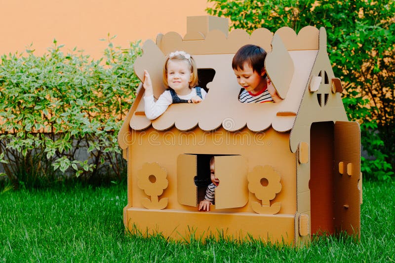 Children are Playing in Cardboard Kid House. Child Having Fun Outdoors ...