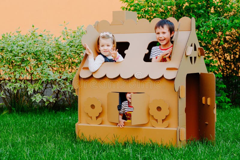 Children are Playing in Cardboard Kid House. Child Having Fun Outdoors ...
