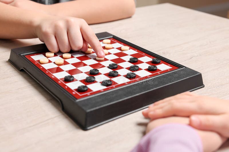 Children Playing Checkers at Light Wooden Table, Closeup Stock Image ...