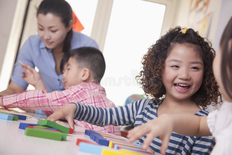 Children Playing in a Classroom Stock Photo - Image of focus, blue ...