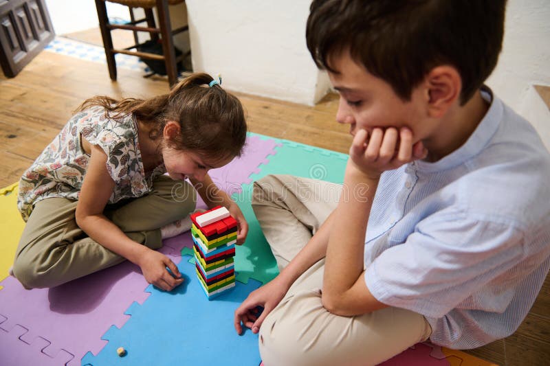 Children Playing with Colorful Blocks on a Colorful Floor Mat Stock ...