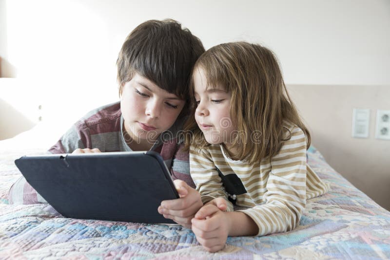 Children Playing with a Digital Tablet Stock Photo - Image of living ...