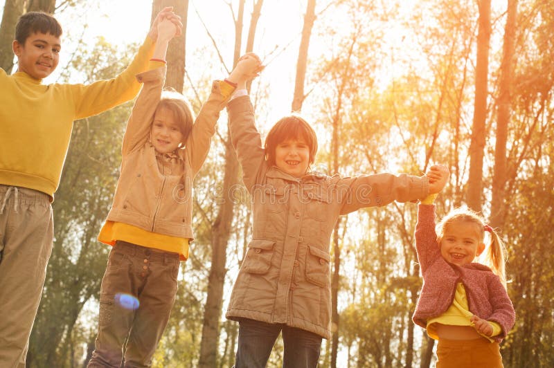 Children Playing in Fall Leaves. Happy Children Throw Fallen L Stock ...