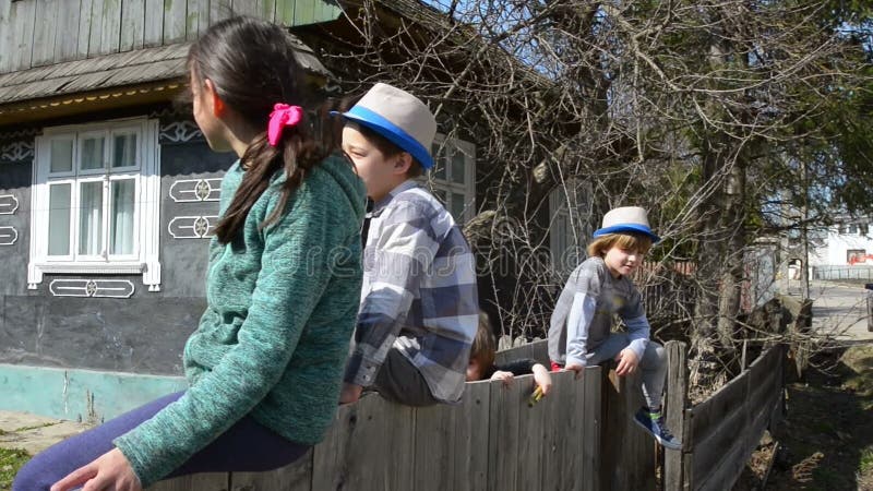 Children Playing on Fence stock video. Video of country - 135023399