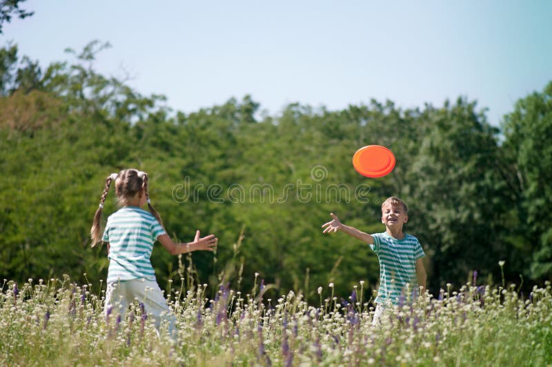 Children playing frisbee stock photo. Image of friend - 26714920