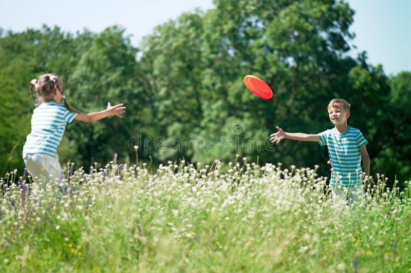 Children playing frisbee stock photo. Image of friend - 26714920