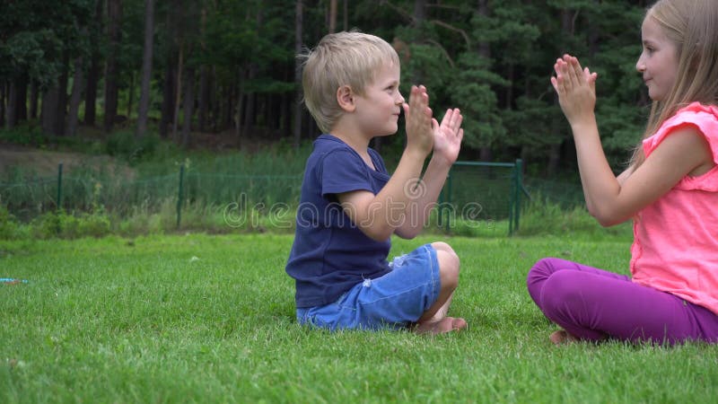 Children Playing on the Grass Stock Video - Video of looking, garden ...