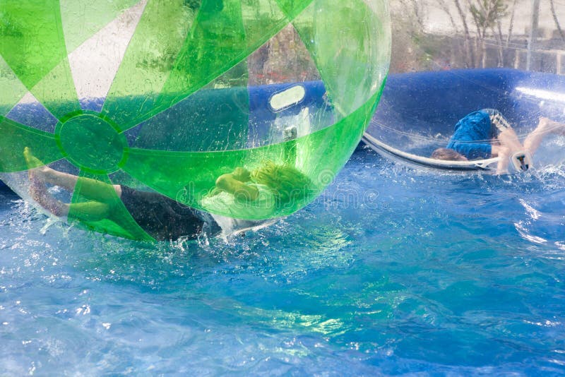 Children Playing in an Inflatable Plastic Balloon on the Water Stock ...