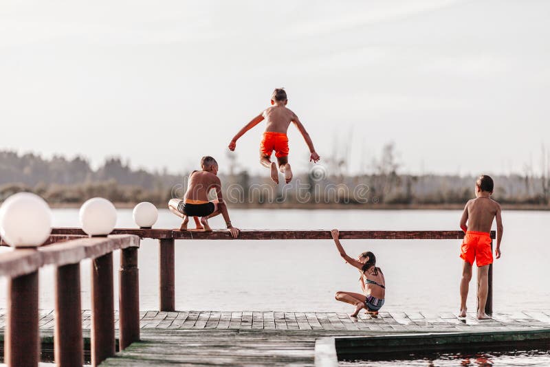 Children Playing and Jumping into the Water in Swimsuits Editorial ...