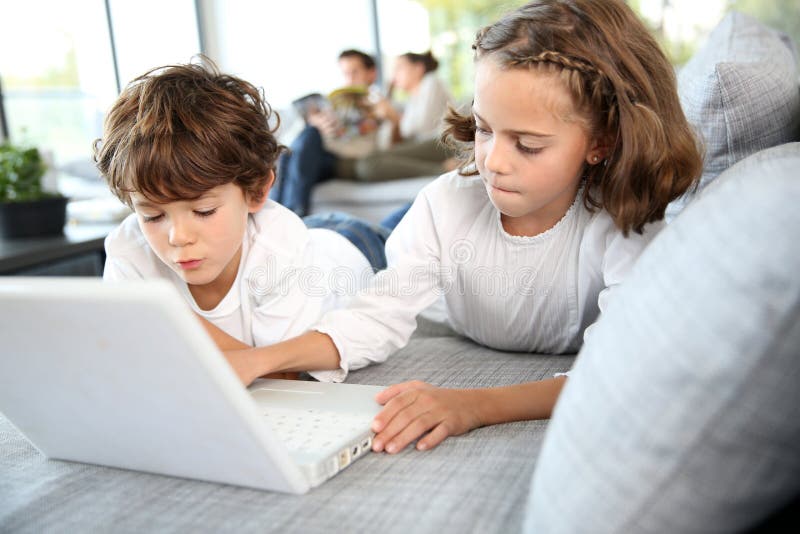 Children playing on laptop stock image. Image of house - 64675307