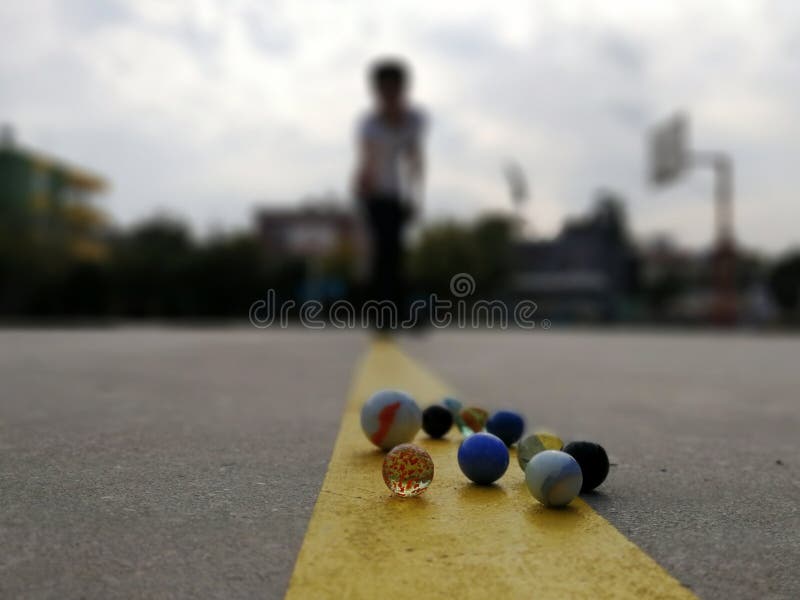 Marbles on the Sidewalk in the Light of the Setting Sun Stock Image ...