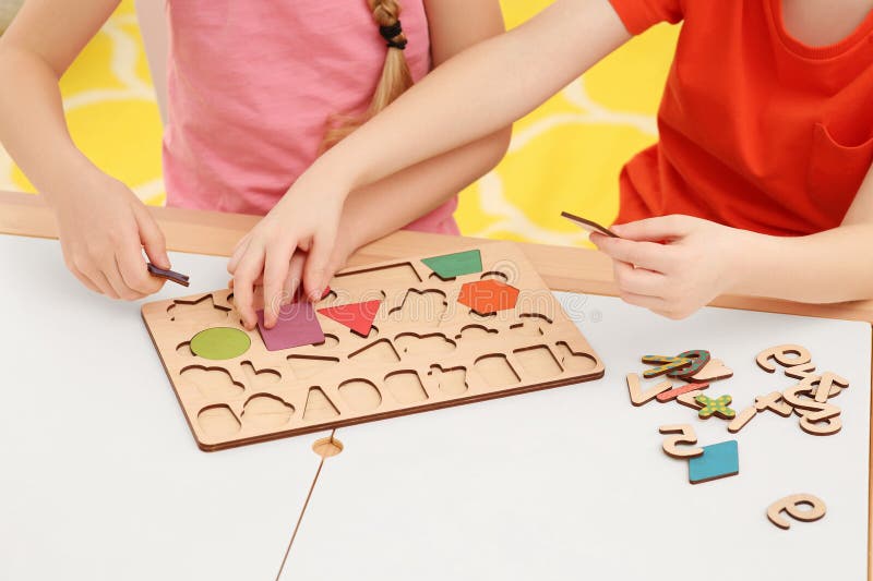 Children Playing with Math Game Kit at Desk Indoors, Closeup. Learning ...