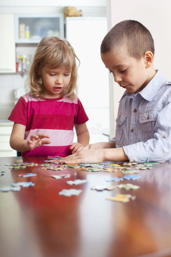 Children, playing puzzles stock image. Image of elementary - 18717641