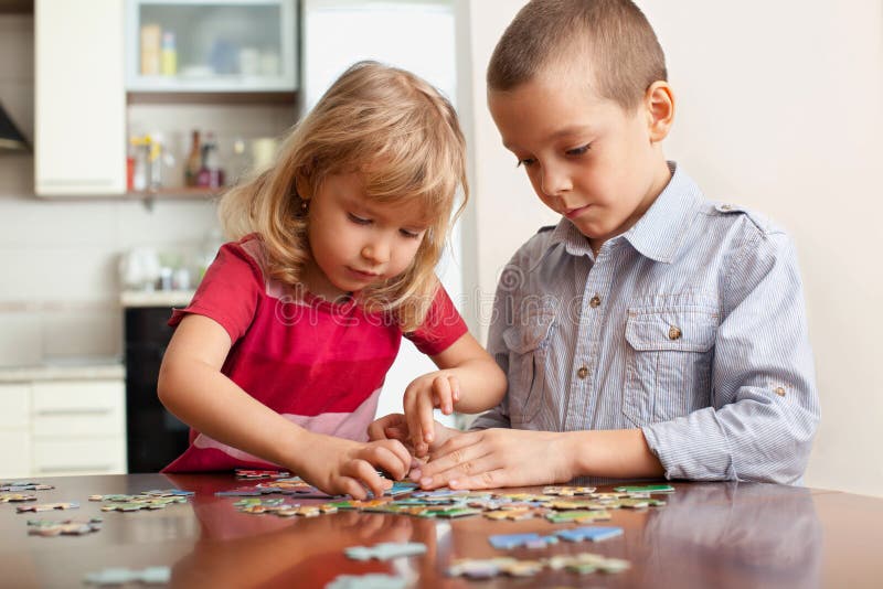 Children, playing puzzles stock image. Image of children - 18717647