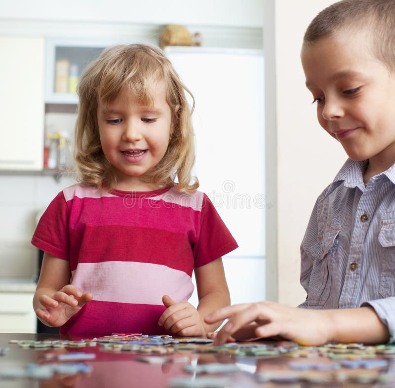 Children, playing puzzles stock image. Image of people - 18717649