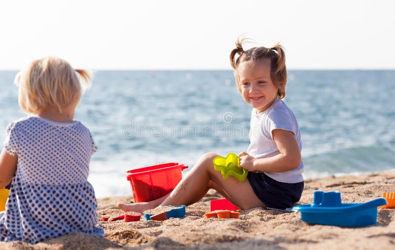 Children playing with sand stock image. Image of months - 137803581