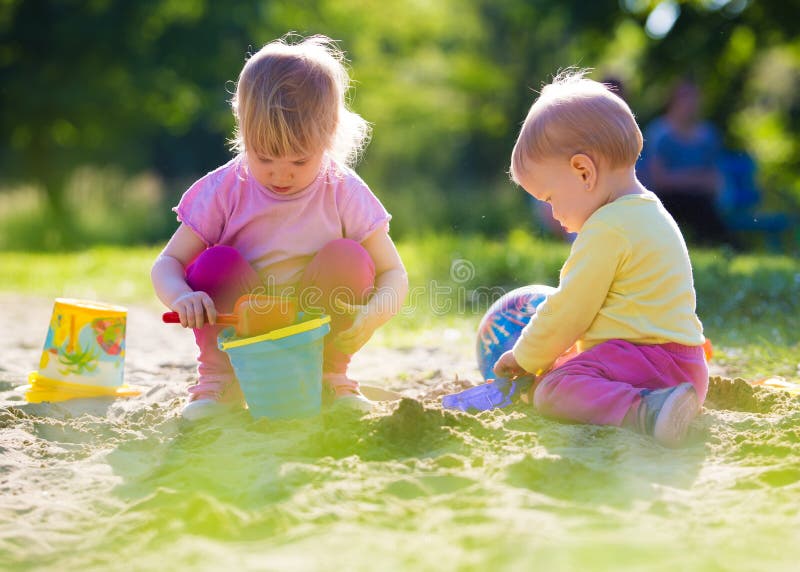 Two Children Playing In A Sandbox Stock Photo - Image of friends ...