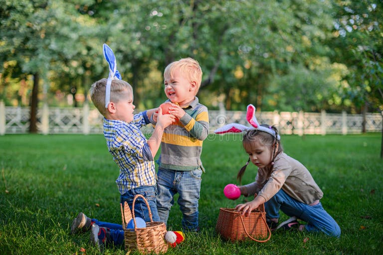Children Playing and Sharing Easter Eggs during Outdoor Hunt Stock ...