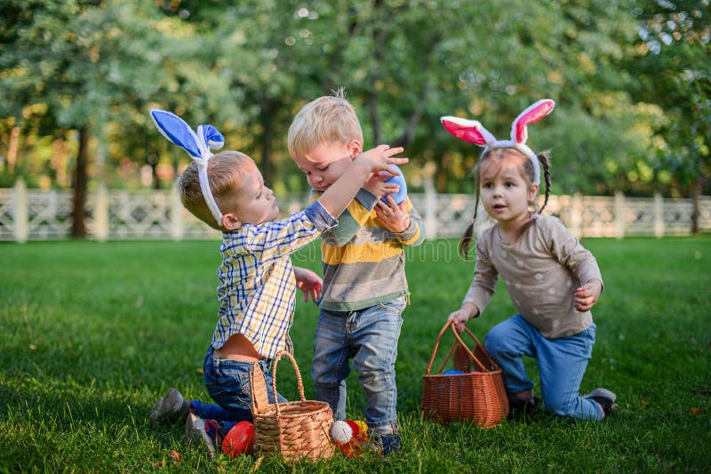 Children Playing and Sharing Easter Eggs during Outdoor Hunt Stock ...