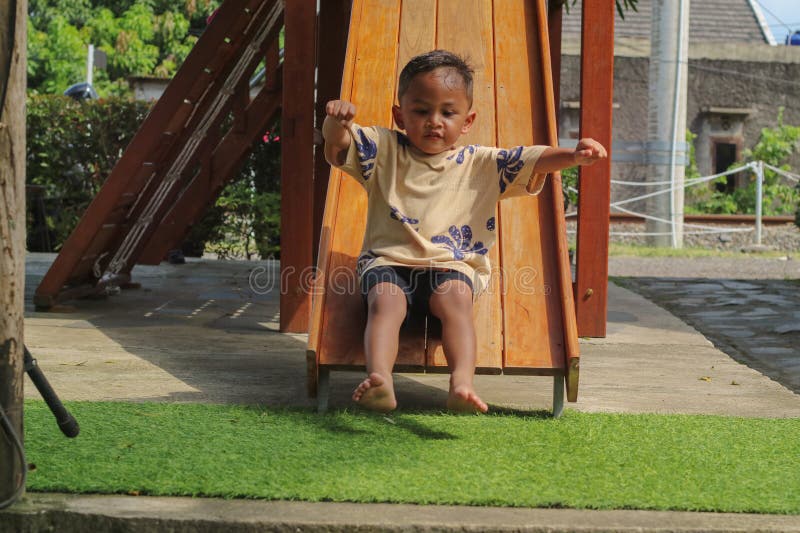 Children Playing on a Slide at the Playground Stock Photo - Image of ...