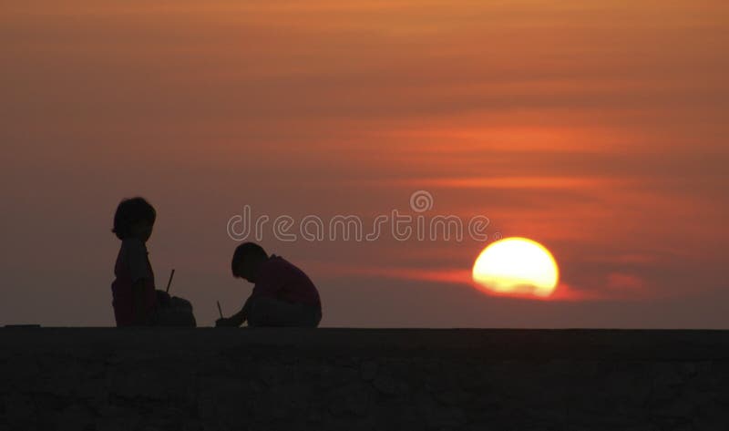 Children Playing at Sunset stock image. Image of dark - 22298291