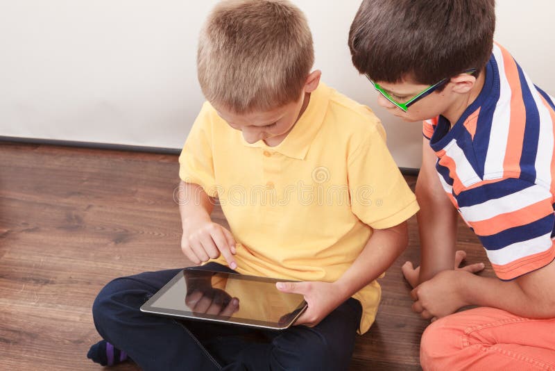 Kids playing on tablet. stock photo. Image of girl, room - 61965116