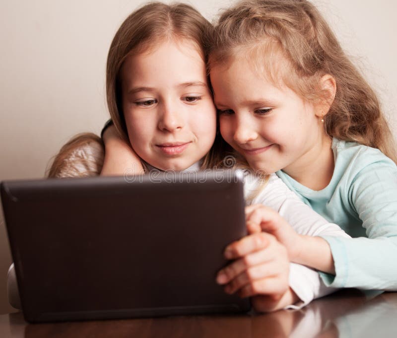Children playing on tablet stock photo. Image of offspring - 155106076