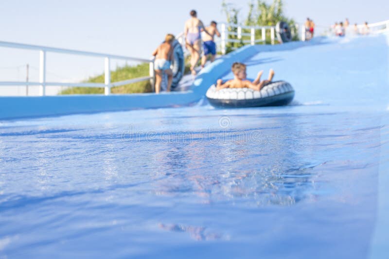 Children Playing on Water Slider Stock Image - Image of emotion, slide ...