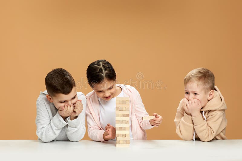 Children Plays with Wooden Constructor on Desk. Stock Image - Image of ...