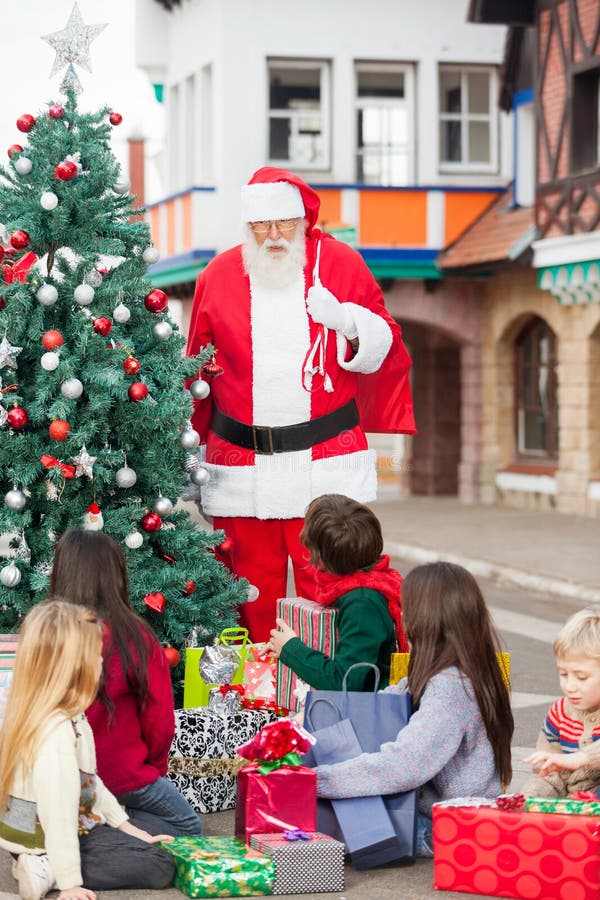 Children with Presents Looking at Santa Claus Stock Photo - Image of ...