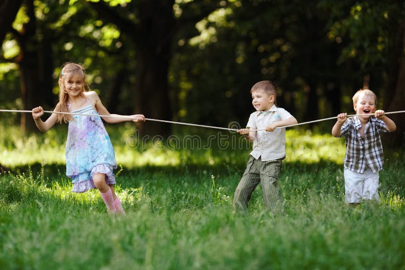Children Pulling the Rope Outdoors Stock Image - Image of happy, girl ...