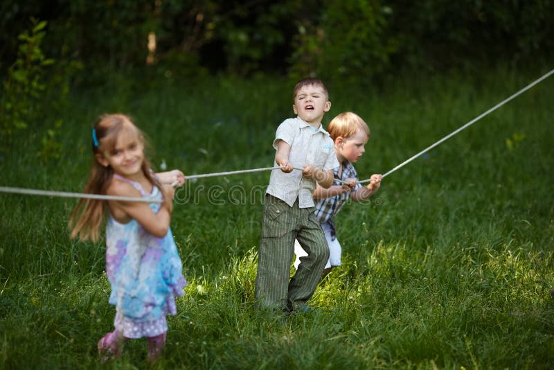 Children Pulling the Rope Outdoors Stock Photo - Image of kids, park ...