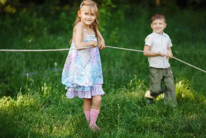 Children Pulling the Rope Outdoors Stock Image - Image of casual, happy ...