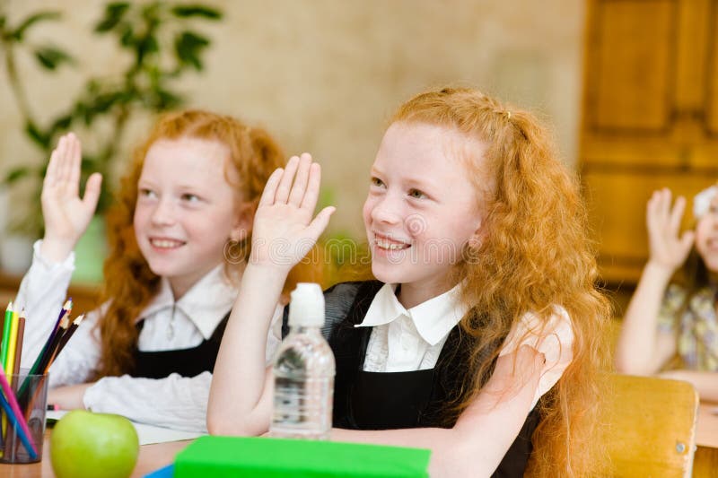 Children Raising Hands Knowing the Answer To the Question Stock Photo ...