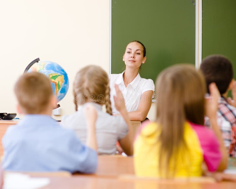 Children Raising Hands Knowing the Answer To the Question Stock Photo ...