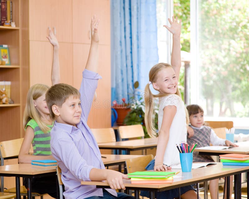 Children Raising Hands Knowing the Answer To the Question Stock Photo ...