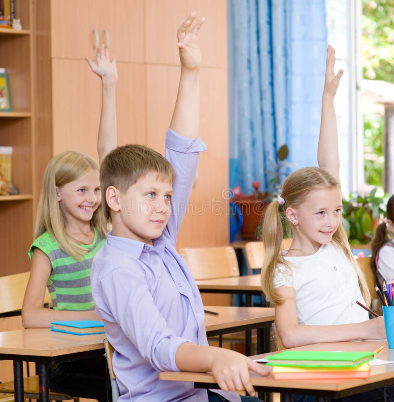 Children Raising Hands Knowing the Answer To the Question Stock Photo ...