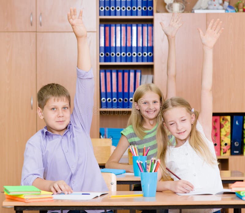 Children Raising Hands Knowing the Answer To the Question Stock Photo ...