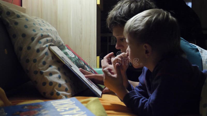 Children Read a Book in Bed at Night. Stock Footage - Video of baby ...