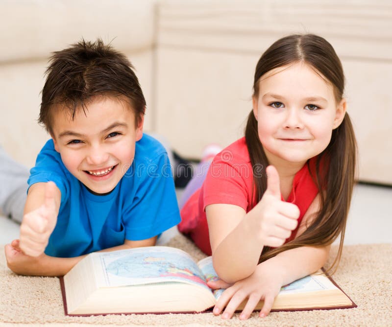 Two Young Children Reading Book at Home Stock Photo - Image of relaxed ...