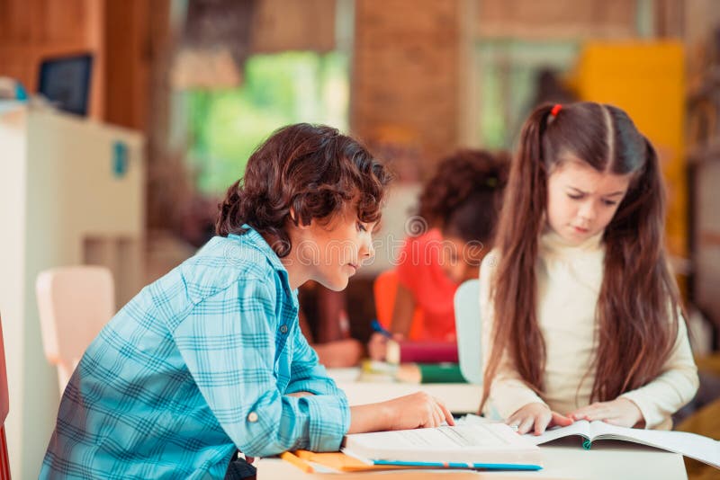 Children Reading a Book during Their English Class Stock Photo - Image ...