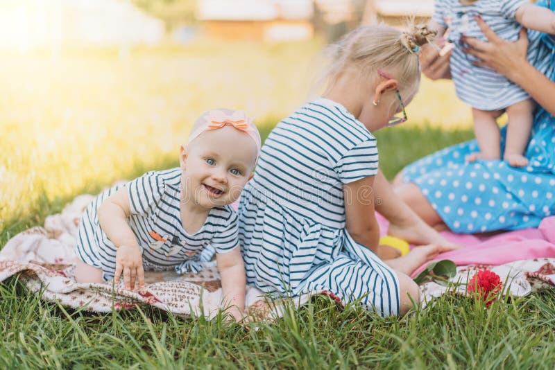 Children are Relaxing Outside while Sitting on Blanket Stock Image ...