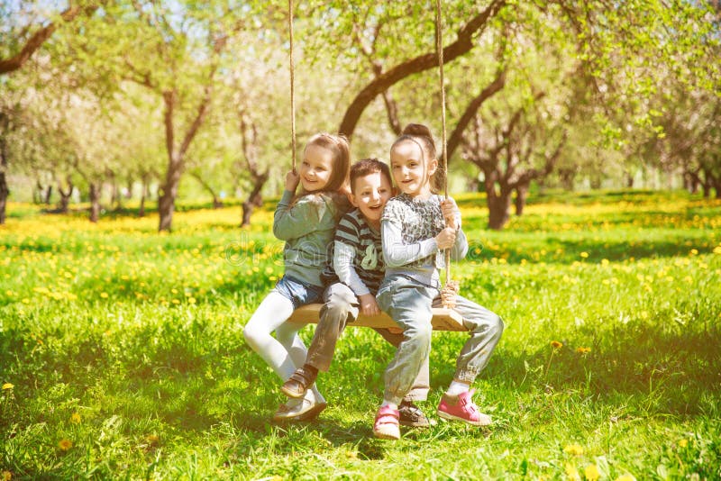 Children rest on a swing stock image. Image of domestic - 59850847