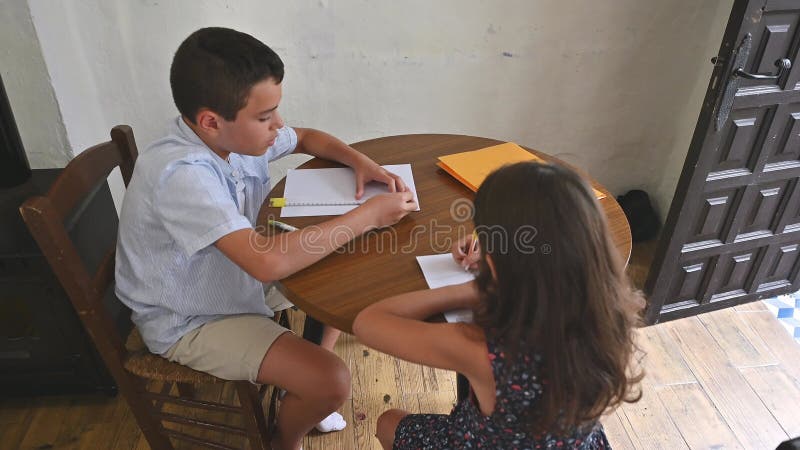 Children Returning To School, Engaged in Homework, Studying at a Table ...