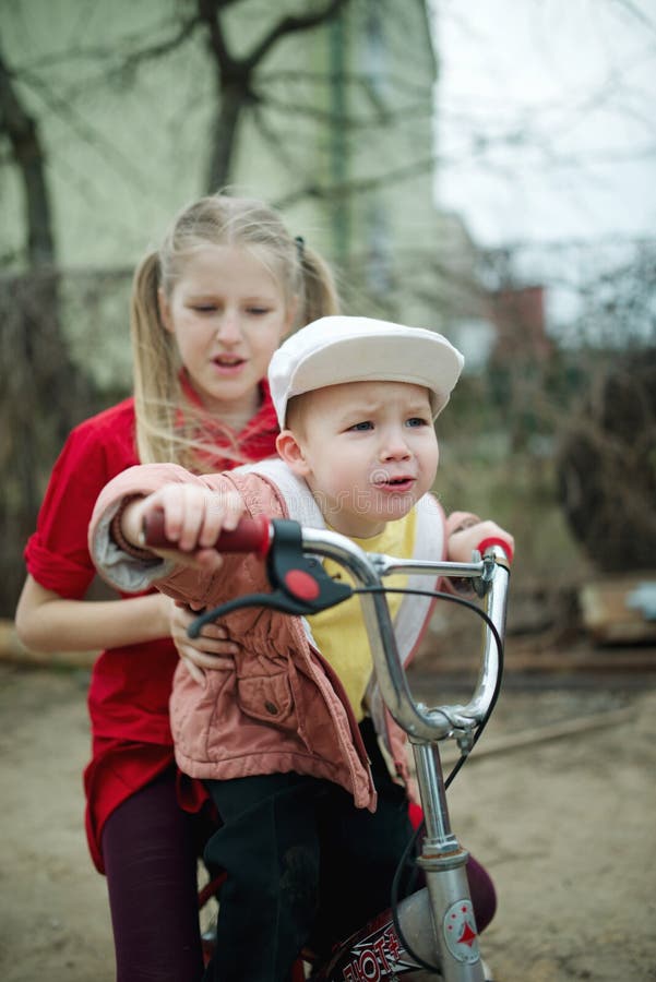 Children Ride on Bicycle in Yard Stock Image - Image of girl, together ...