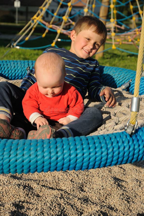Children on round swing stock photo. Image of light, sitting - 25040730
