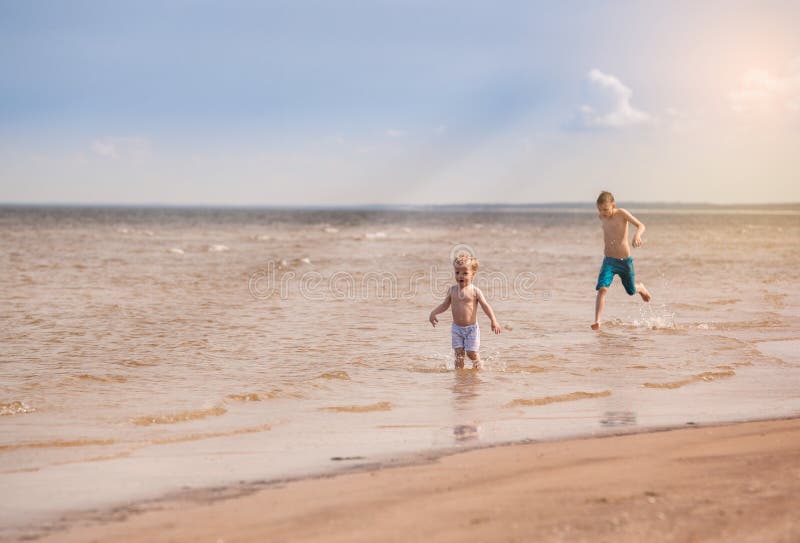 Children Run Along Beach Splatters Water Stock Photos - Free & Royalty ...