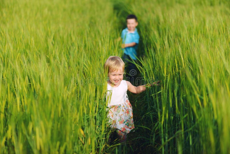 Children Run on Green Field of Wheat Stock Photo - Image of girl ...