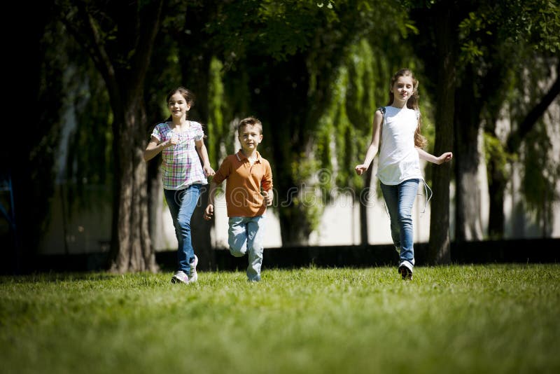 Three Children Running Holding Hands Stock Photo - Image of playing ...