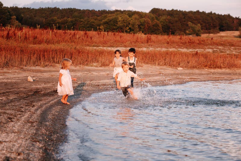 Children Running Along Beach Stock Image - Image of happy, people: 34616527